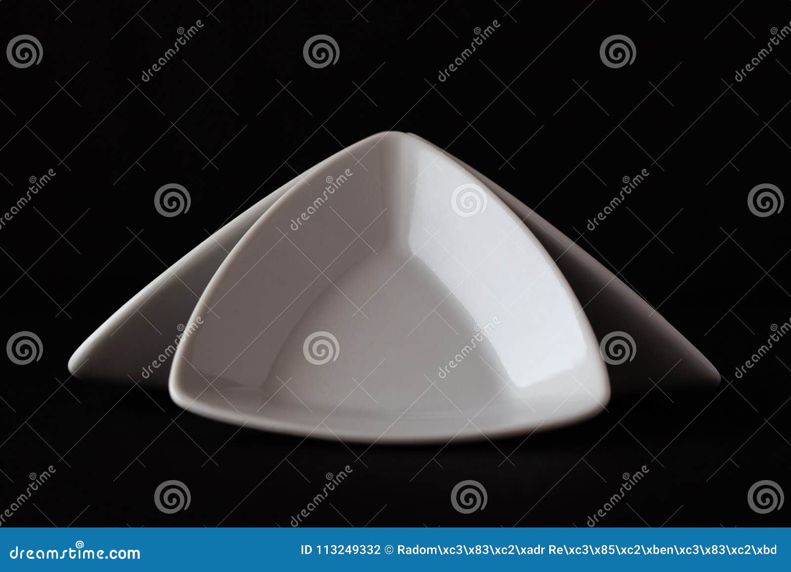 White Triangular Ceramic Bowls with on the Black Background. Stock ...