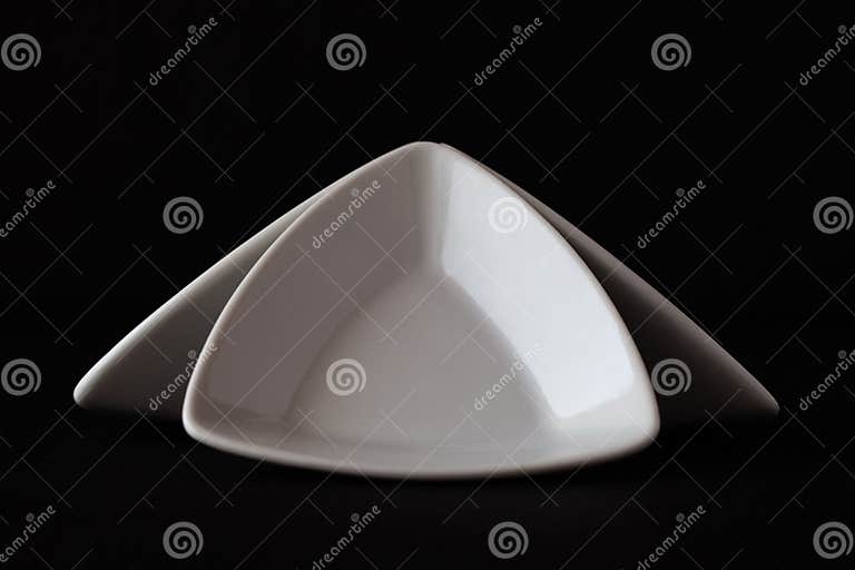 White Triangular Ceramic Bowls with on the Black Background. Stock ...