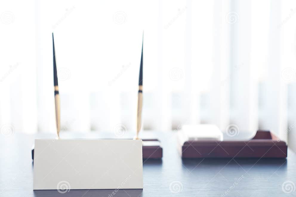 White Triangular Sign for the Label Standing on a Black Table. Stock ...