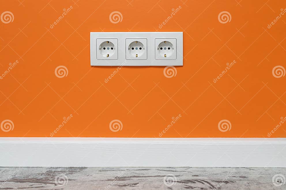 White Triple Outlet on Orange Wall Stock Photo - Image of connection ...