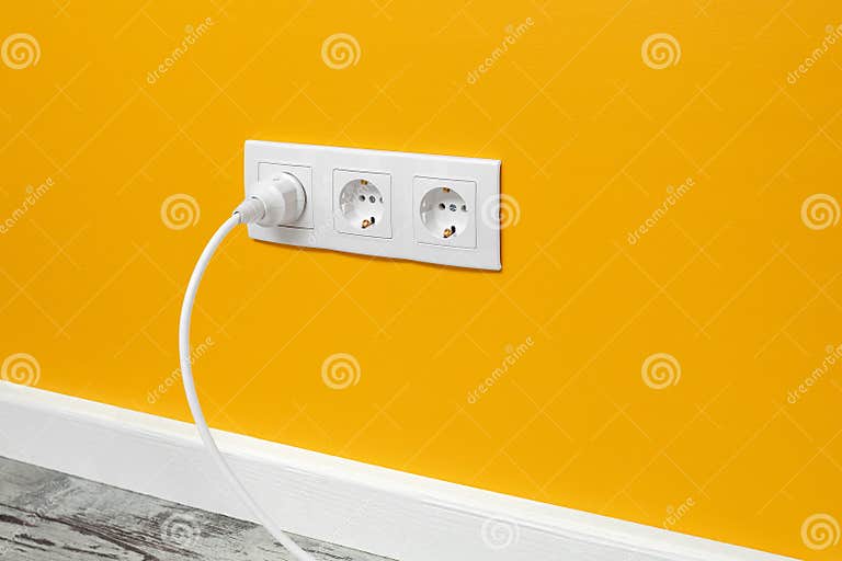 White Triple Outlet on Yellow Wall Stock Image - Image of yellow ...