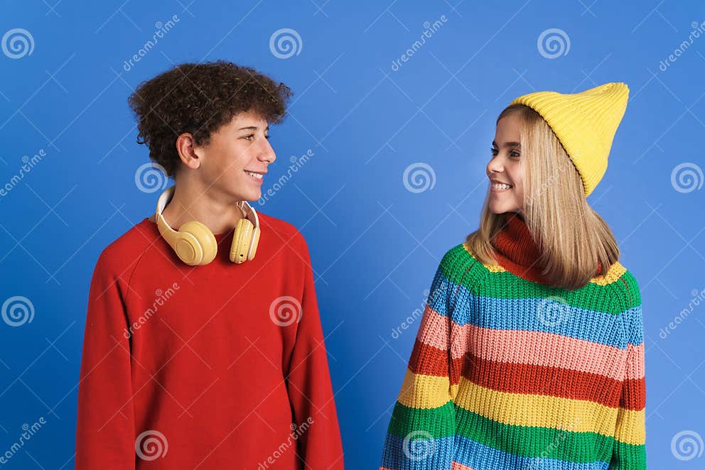 White Two Teenagers Smiling At Each Other While Posing Together Stock