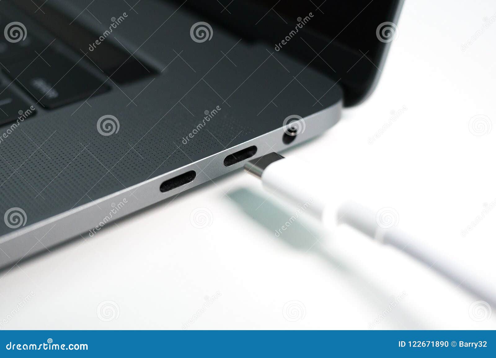A White USB Type C / USB-C Cable Being Plugged into a Modern Notebook ...