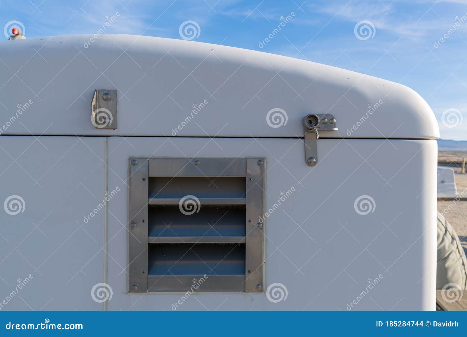 White Enclosure Wall With A Tall Red Firethorn Hedge Above. Metallic ...