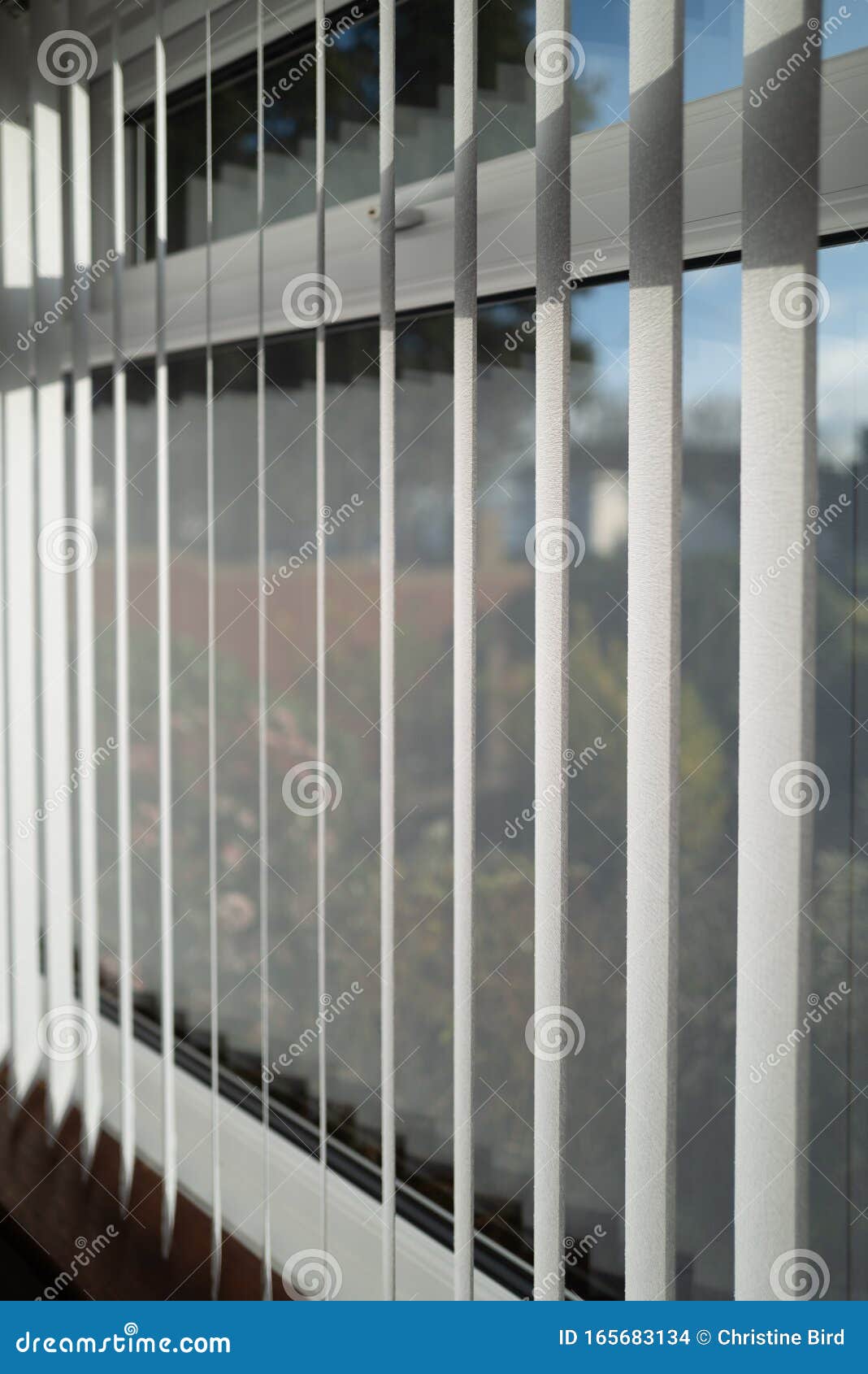 White Vertical Blinds Slats Hanging in Front of Double Glazed White ...