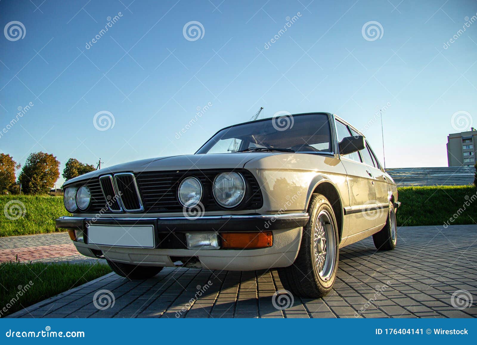 White Vintage Classic Car with Round Headlights with the Blue Sky in ...