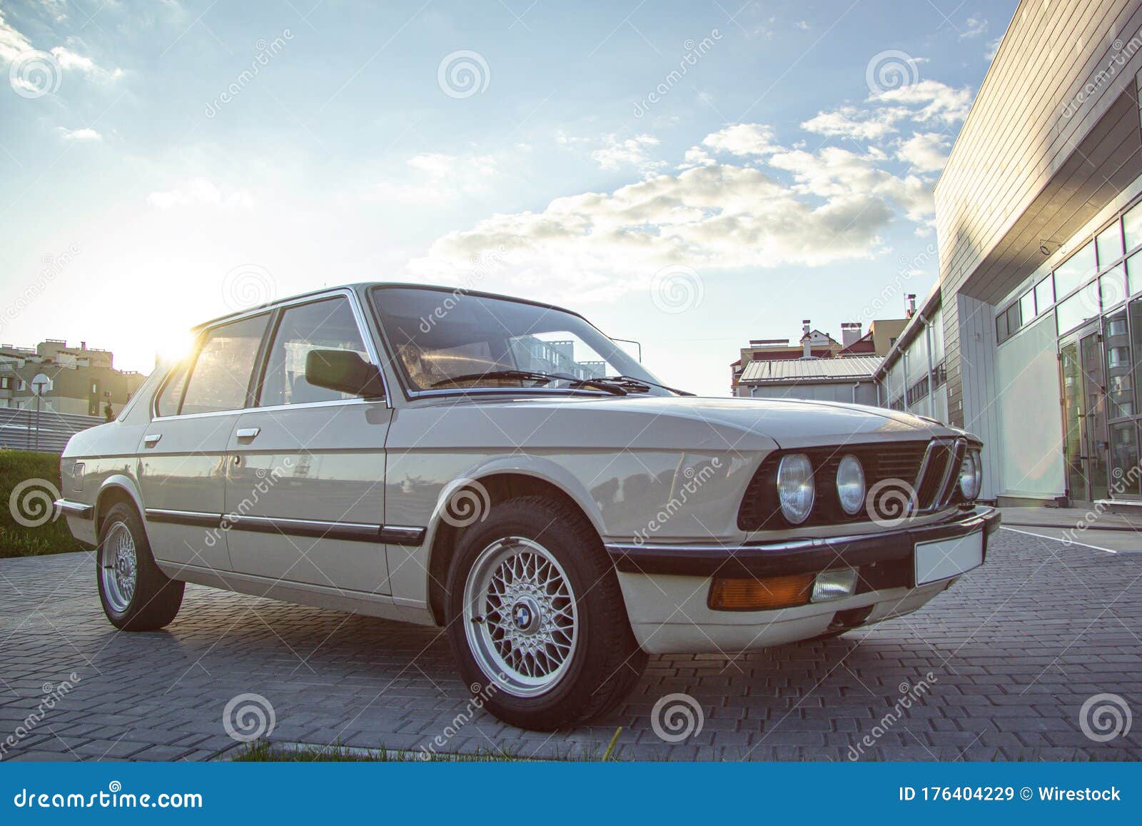 White Vintage Classic Car with Round Headlights with the Blue Sky in ...