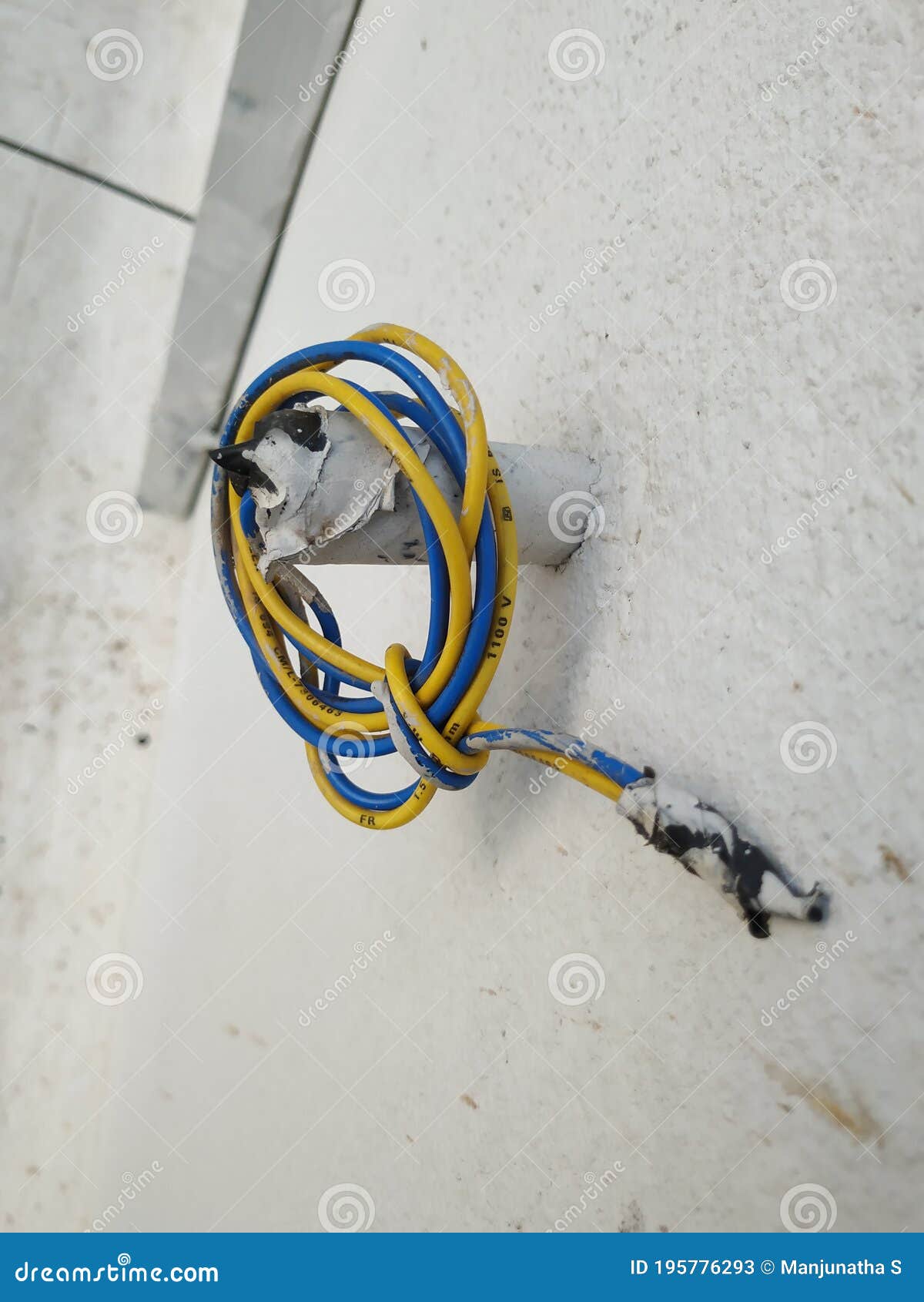White Wall Fixed Small Plastic Pipe and Remaining Used Electrical Wires ...