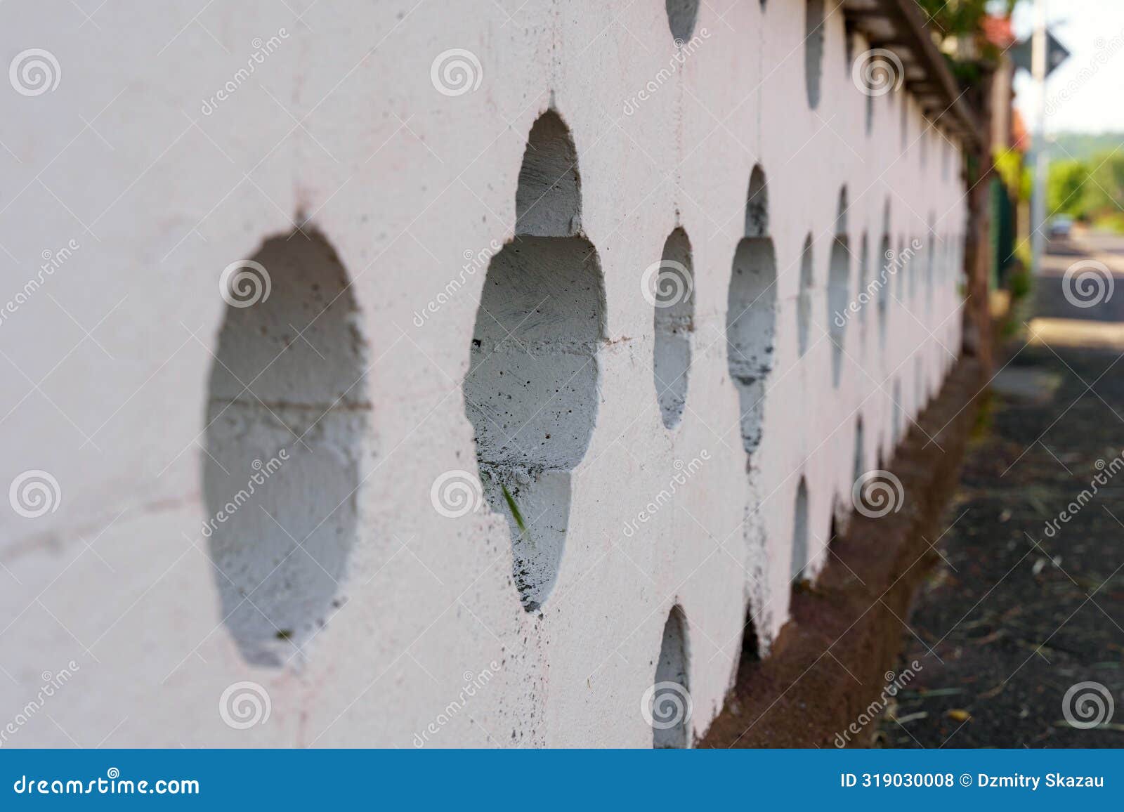 A White Wall with Multiple Holes of Various Sizes, Creating an Abstract ...
