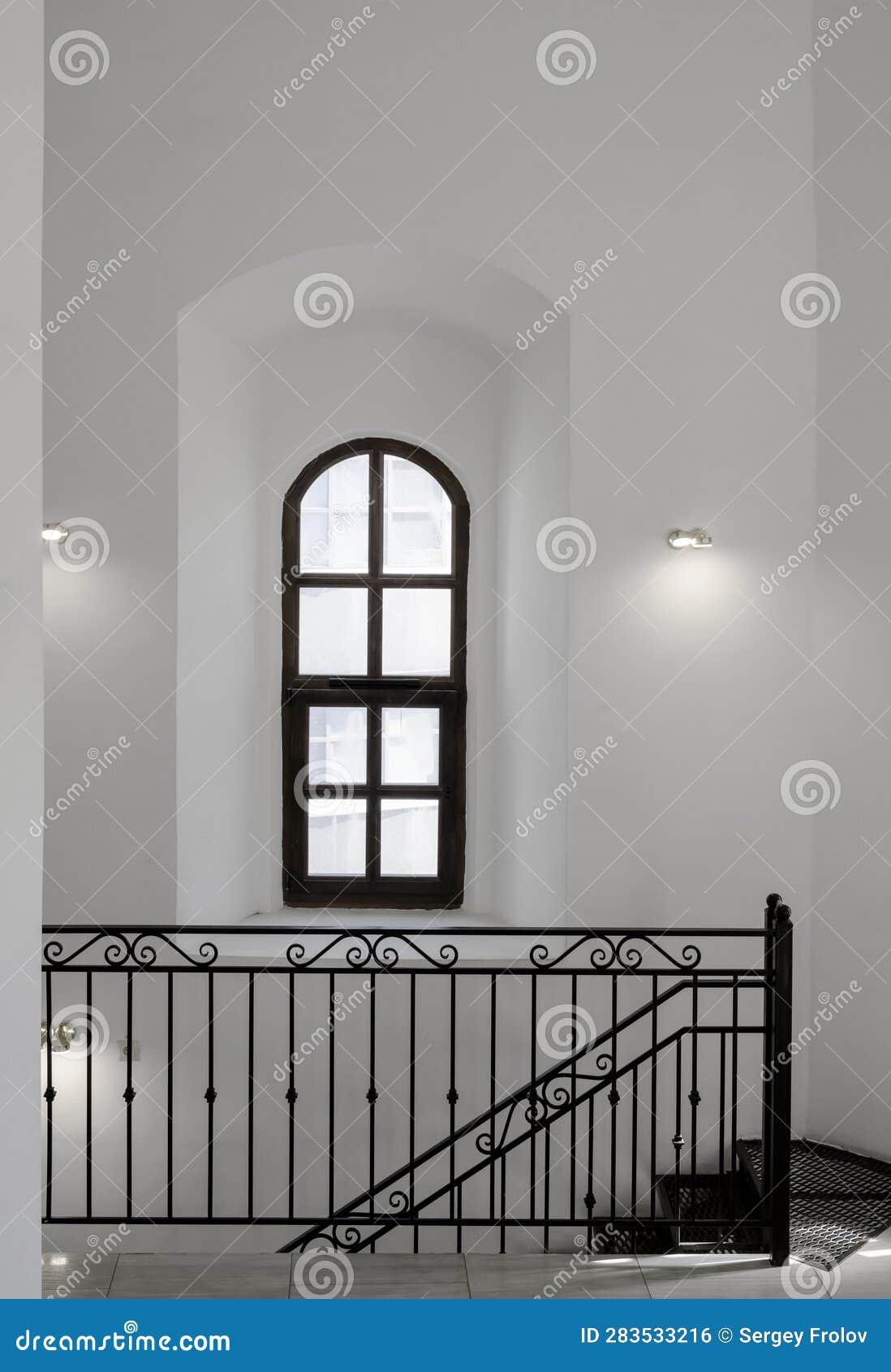 White Walls with a Black Window Frame and Black Iron Railing Stairs in ...