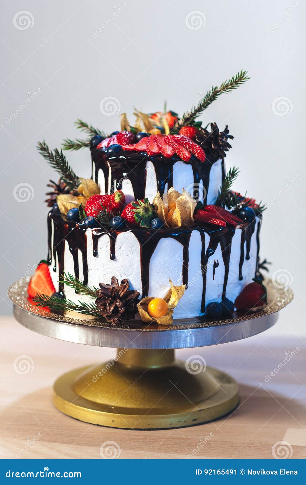 White Wedding Cake with Chocolate and Fruits on a Stand, Vertical Side ...