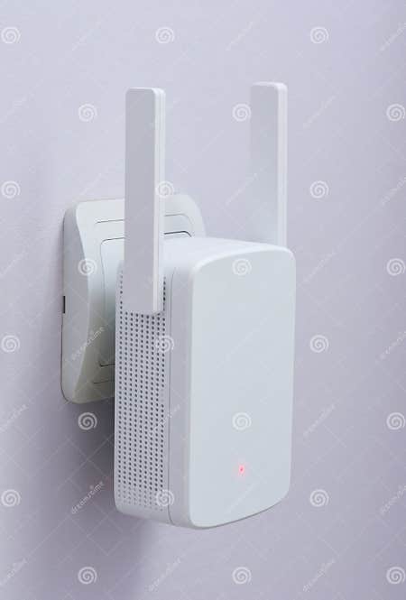White Wi-fi Range Extender Plugged in Electrical Socket Stock Photo ...
