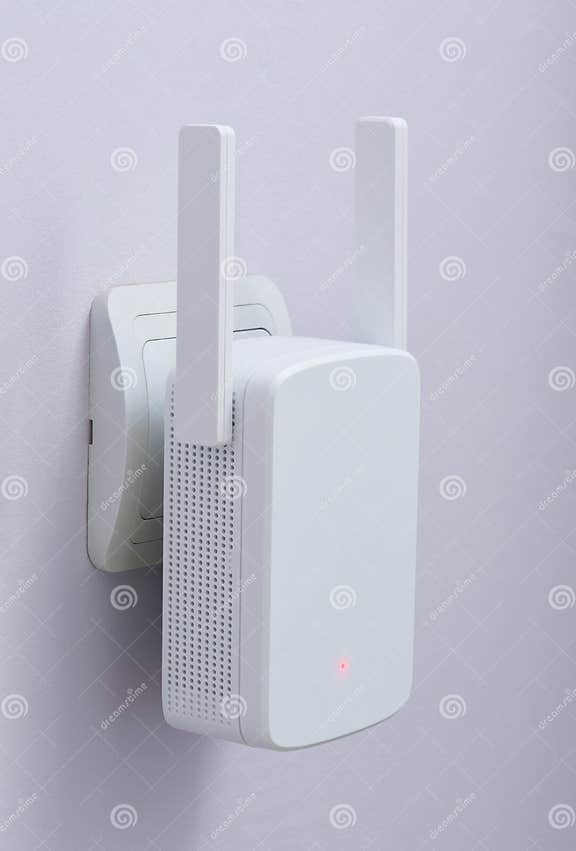 White Wi-fi Range Extender Plugged in Electrical Socket Stock Photo ...