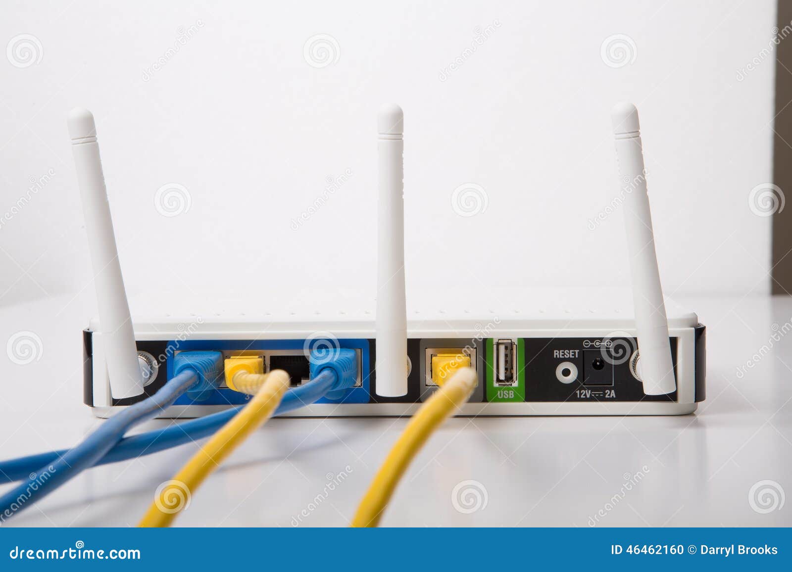 White Wireless Router with Blue and Yellow Cables Stock Photo - Image ...
