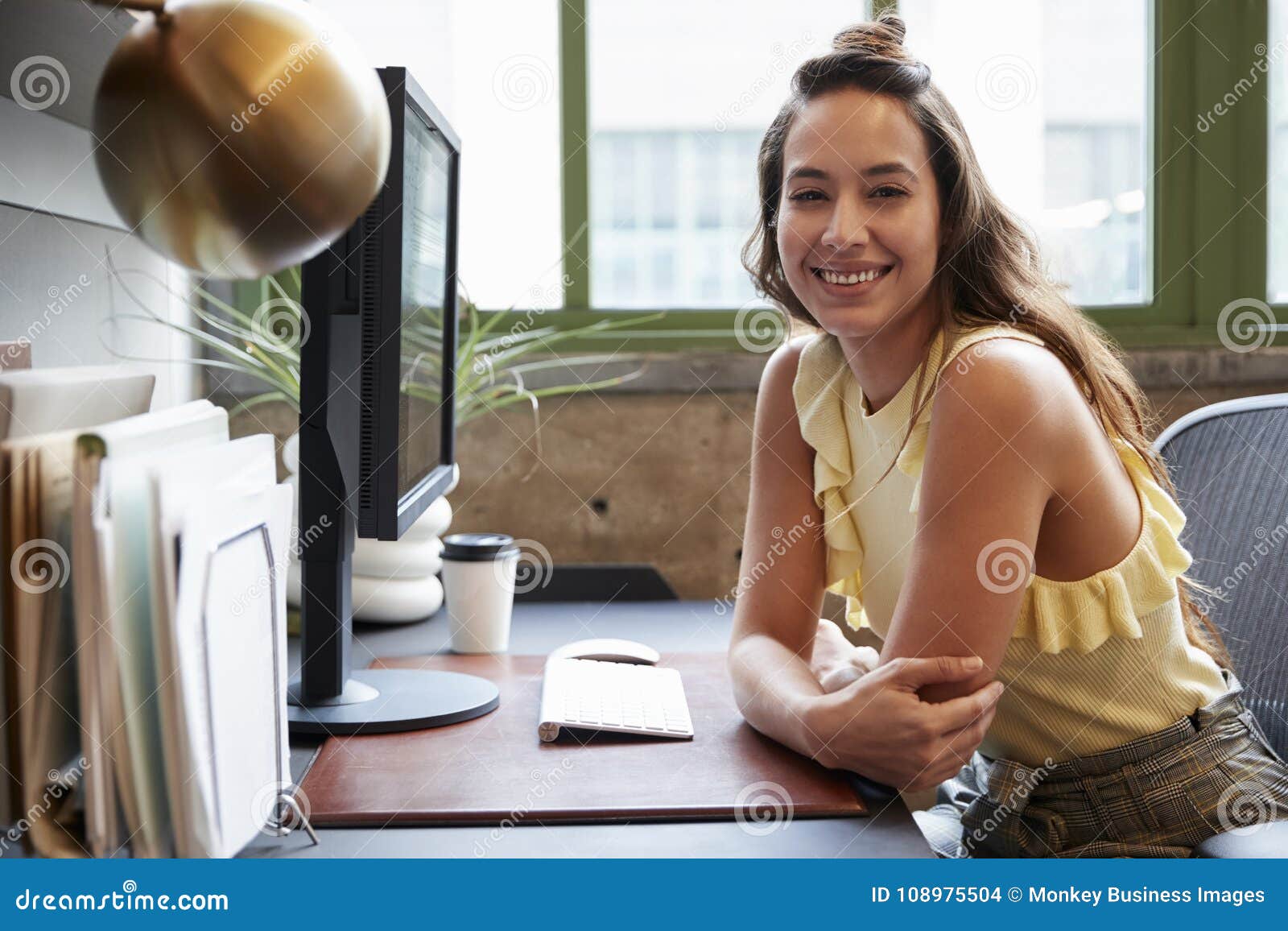 White Woman at a Computer in an Office Smiling To Camera Stock Photo ...