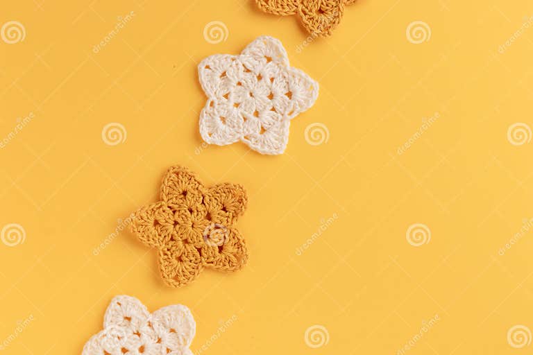 White and Yellow Crocheted Stars Row Pattern on a Yellow Background ...