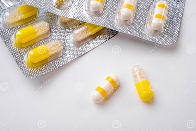 White and Yellow Medication Capsules Stock Image - Image of yellow ...