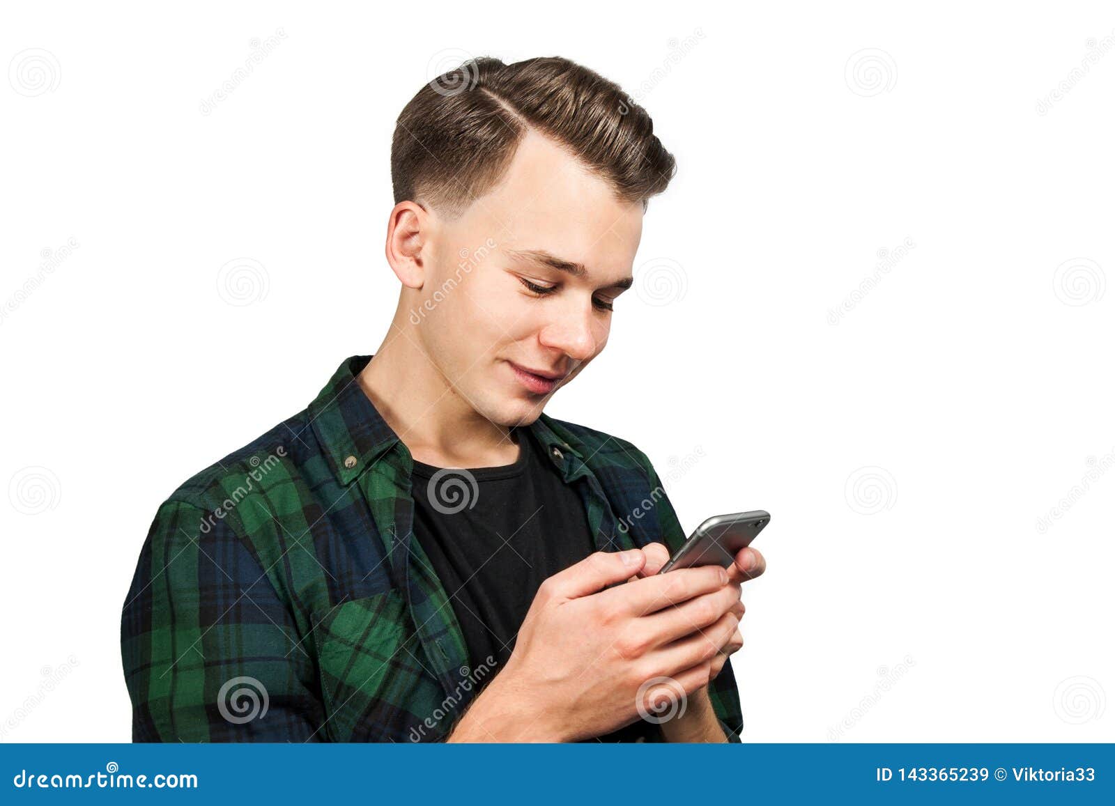 White Young Guy Writes a Message on the Mobile Phone and Smiles ...