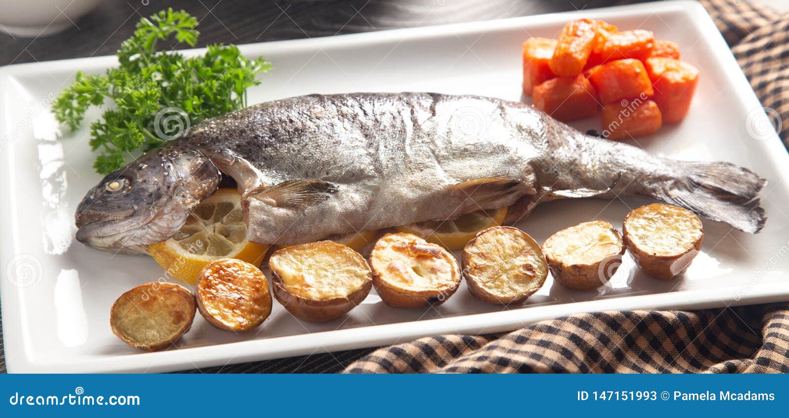 Whole Baked Rainbow Trout on a Table Set for Dinner Stock Image - Image ...