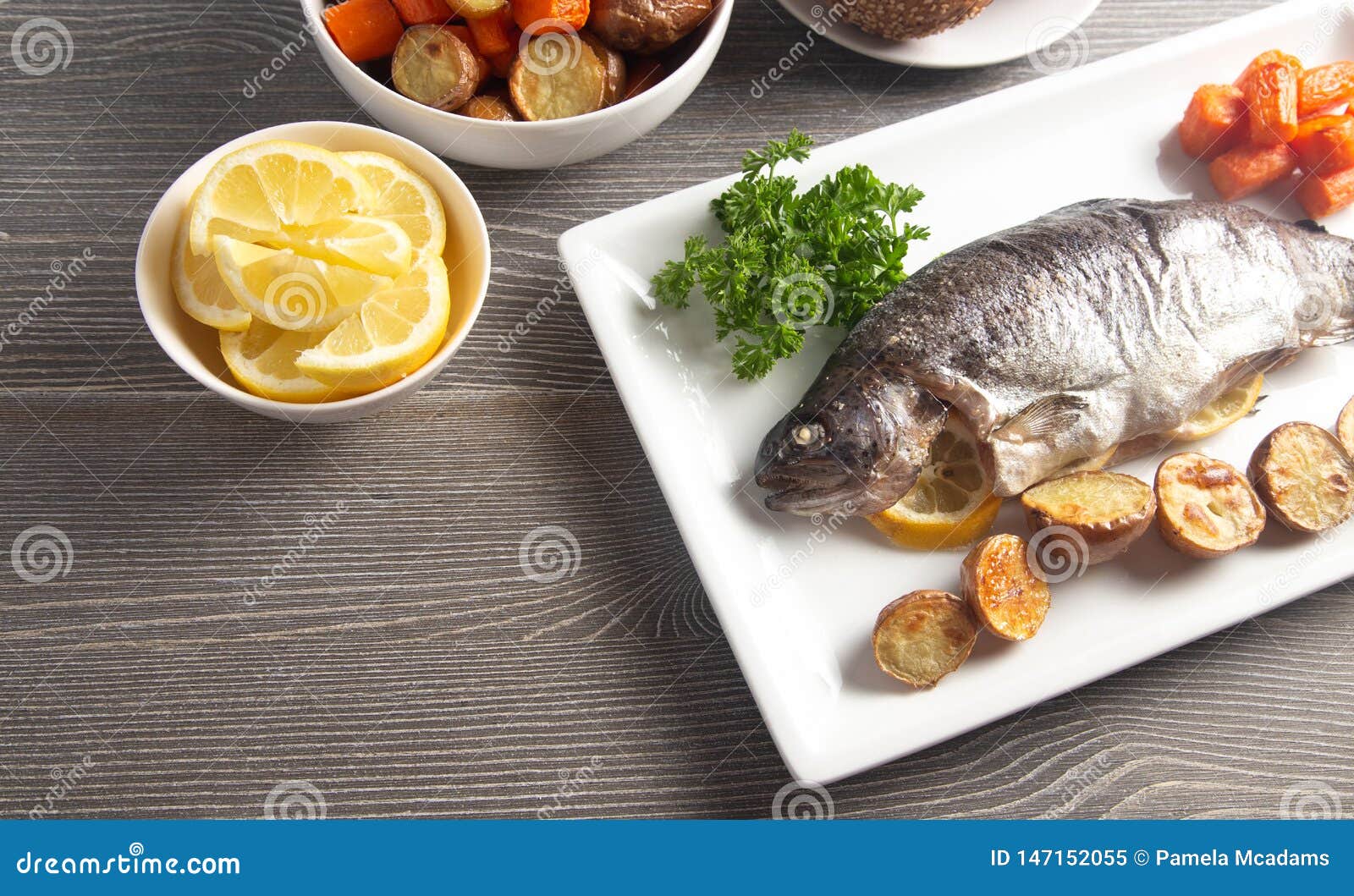 Whole Baked Rainbow Trout on a Table Set for Dinner Stock Image - Image ...