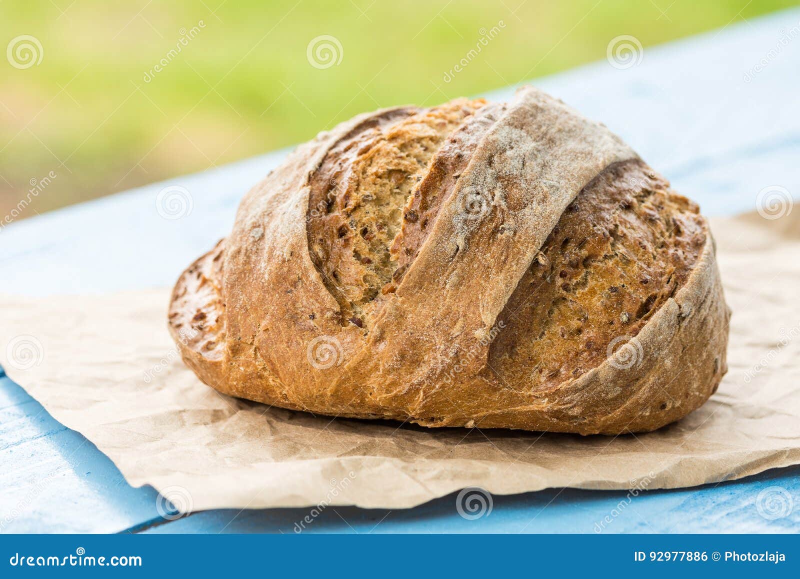 Whole Black Healthy Bread on the Wrinkled Brown Paper Stock Photo ...