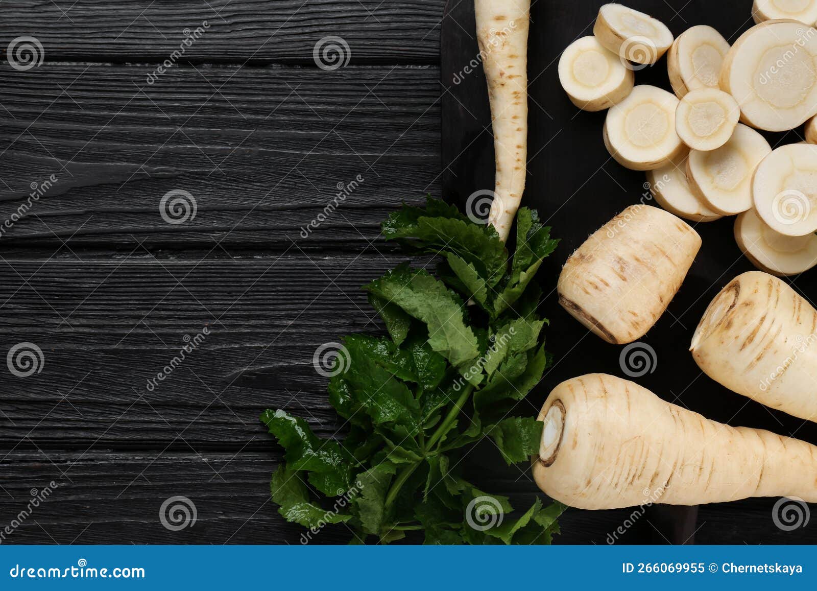 Whole and Cut Parsnips on Black Wooden Table, Flat Lay. Space for Text ...