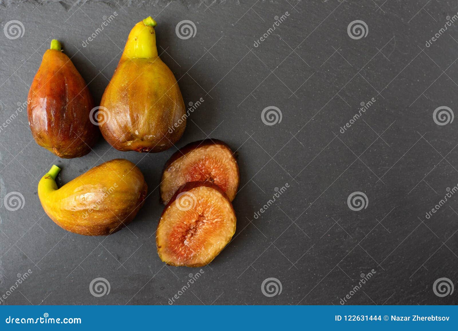 Whole Figs and Fig Sliced on Black Stone Plate. Top View Stock Photo ...