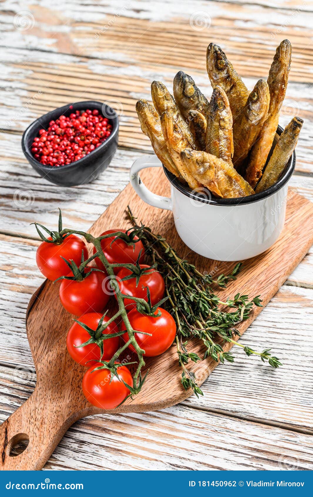 Whole Fried Capelin Fish Served on Cutting Board. White Background ...