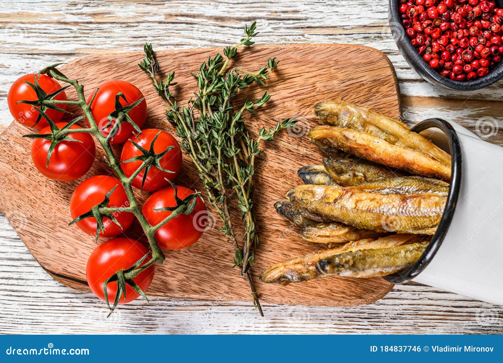 Whole Fried Capelin Fish Served on Cutting Board. White Background ...