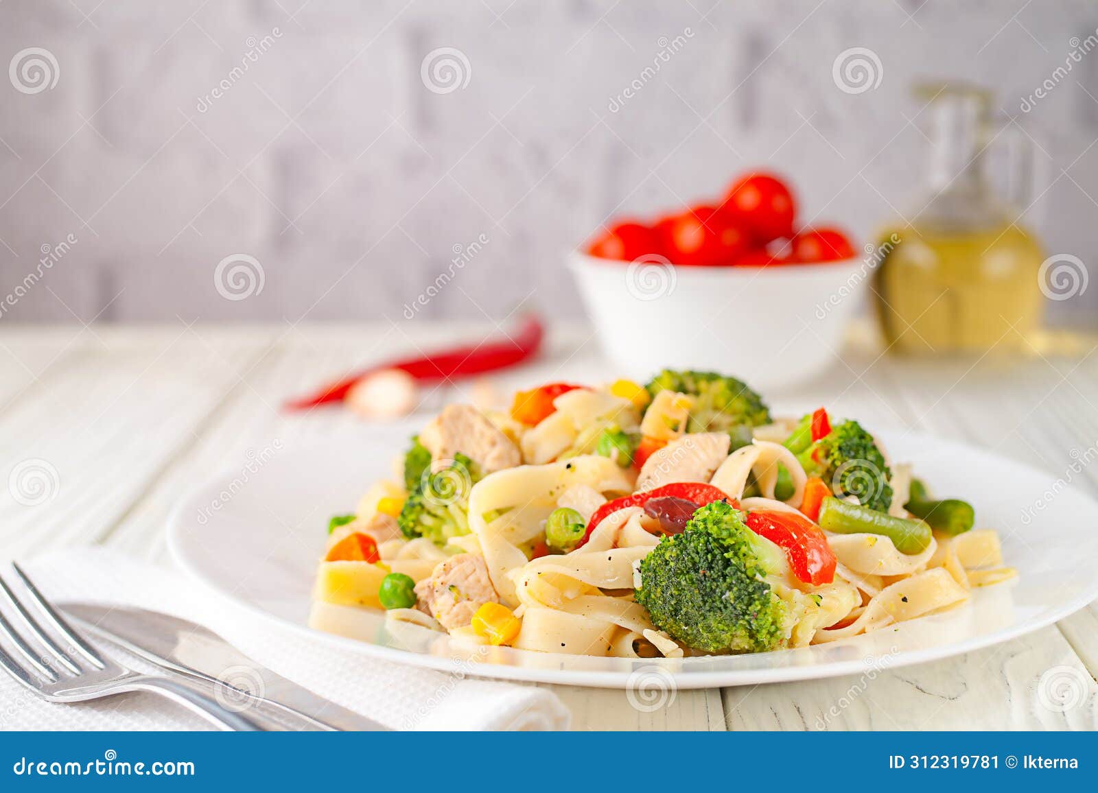 Pasta with Vegetables on a Plate Against a Brick Wall Background Stock ...