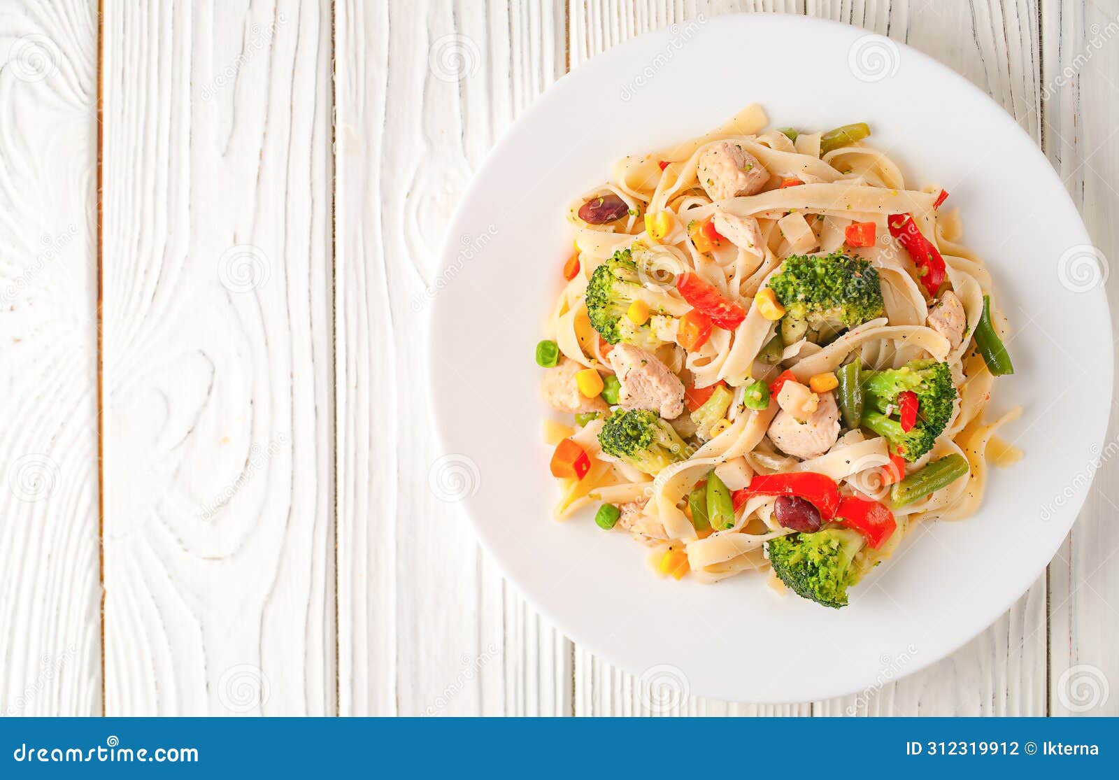 Pasta with Vegetables on a Plate Against a Brick Wall Background Stock ...