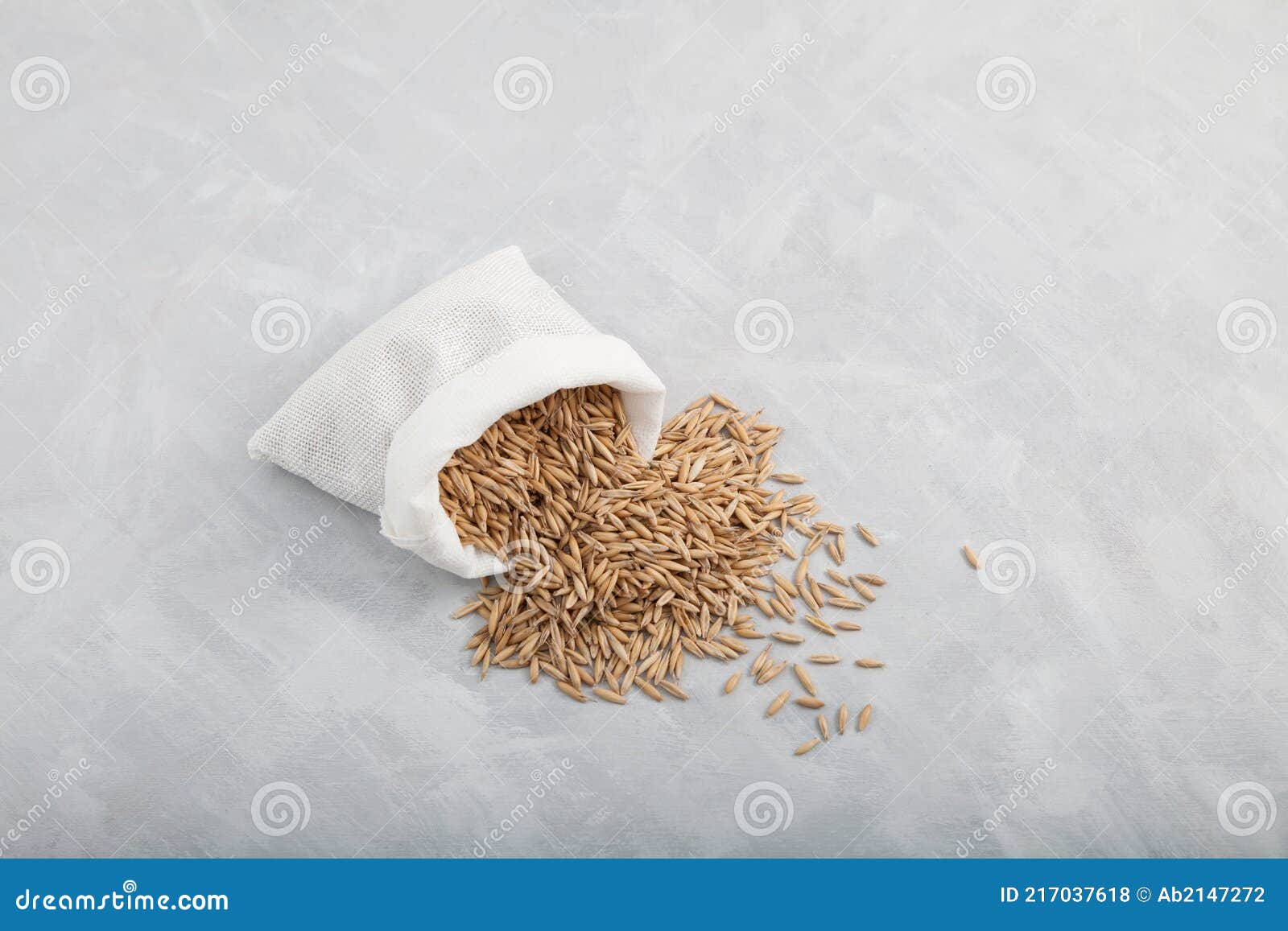 Whole Grains Oats Spilled Out of Bag Onto Grey Surface. Selective Focus ...