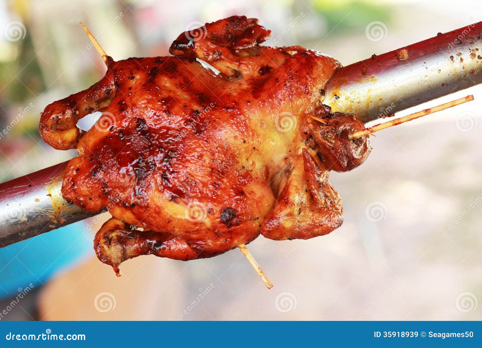 Whole Grilled Chicken on a Grill with Rotating Steel Plug. Stock Image ...