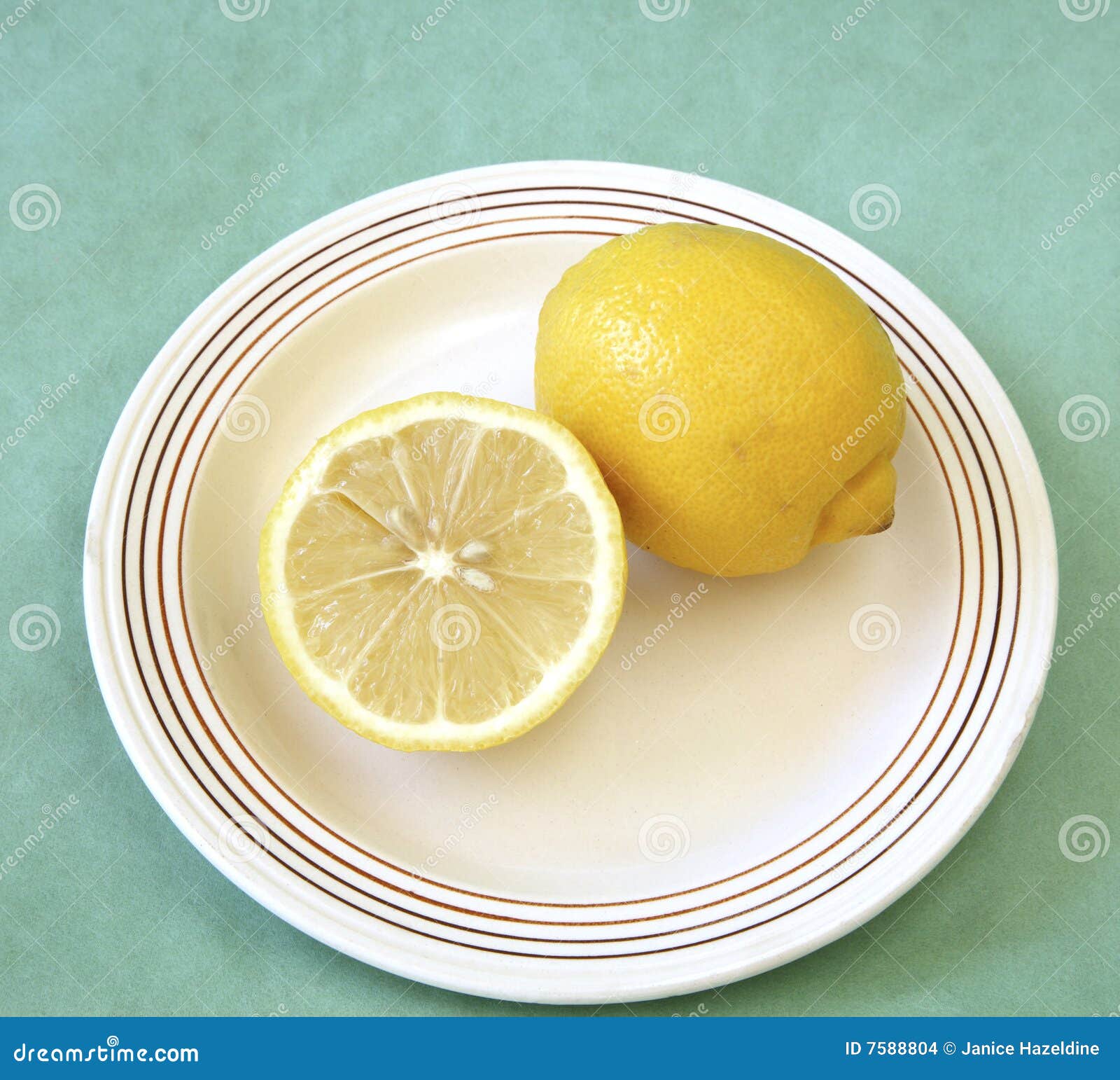 Whole and Half Lemon on Plate Stock Photo - Image of fruits, citrus ...