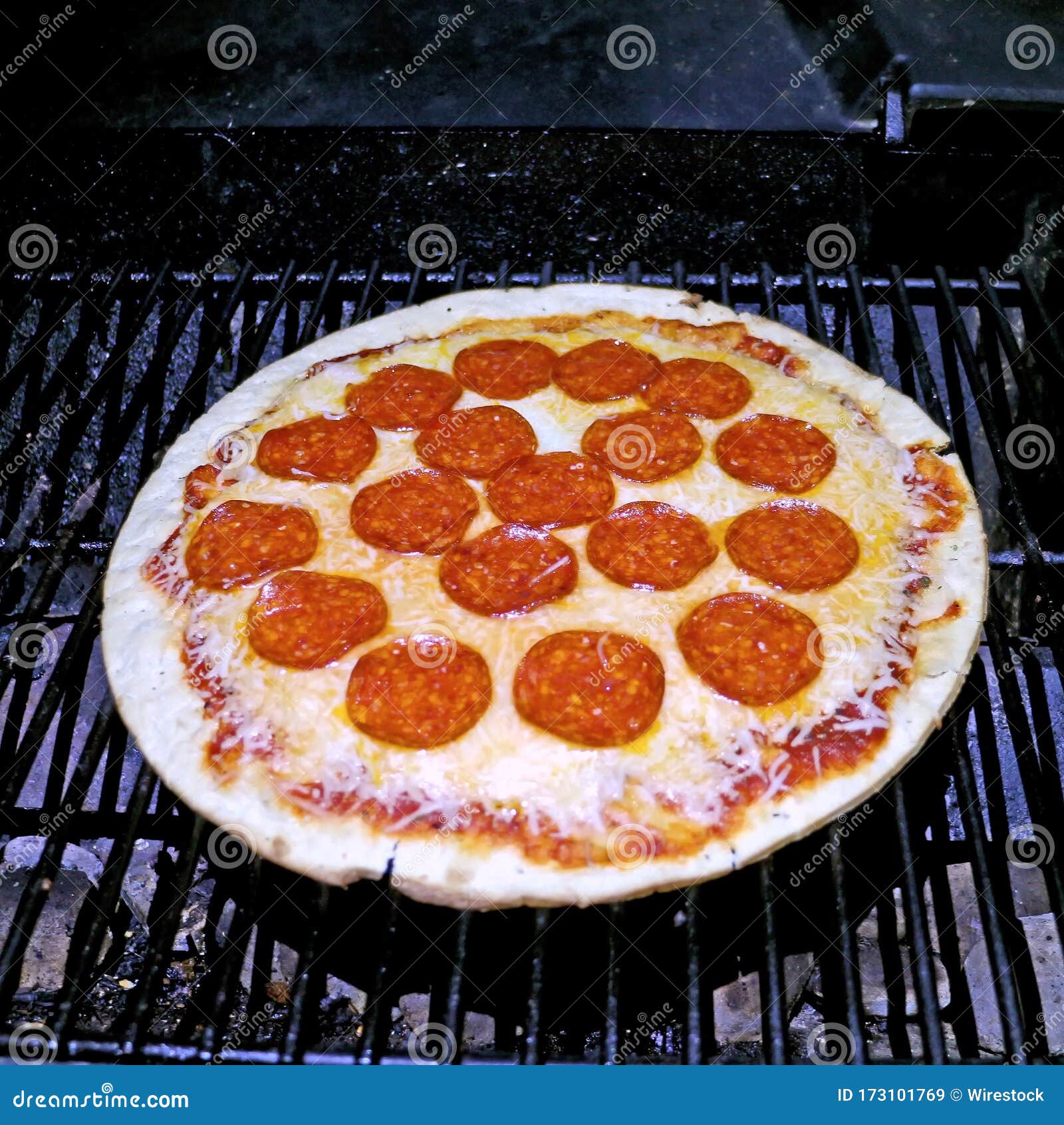 Whole Raw Pepperoni Pizza on a Grilling Machine Stock Image - Image of ...