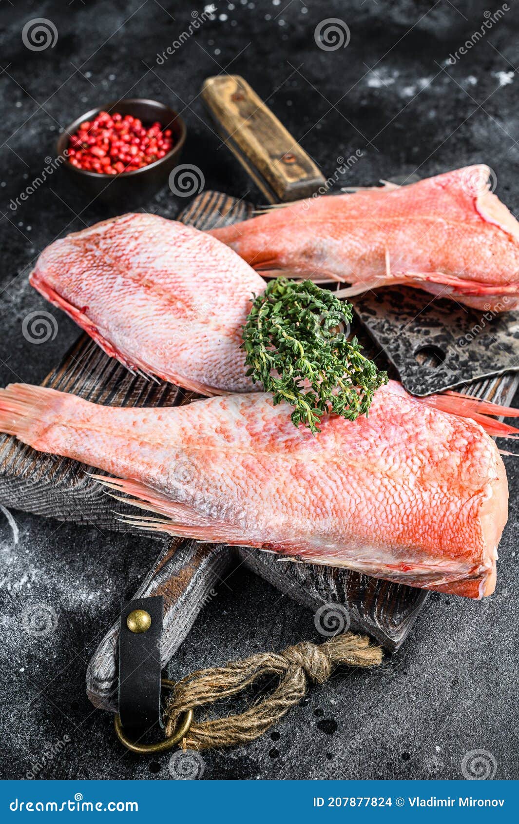 Whole Raw Red Snapper Fish on a Cutting Board. Black Background Stock ...