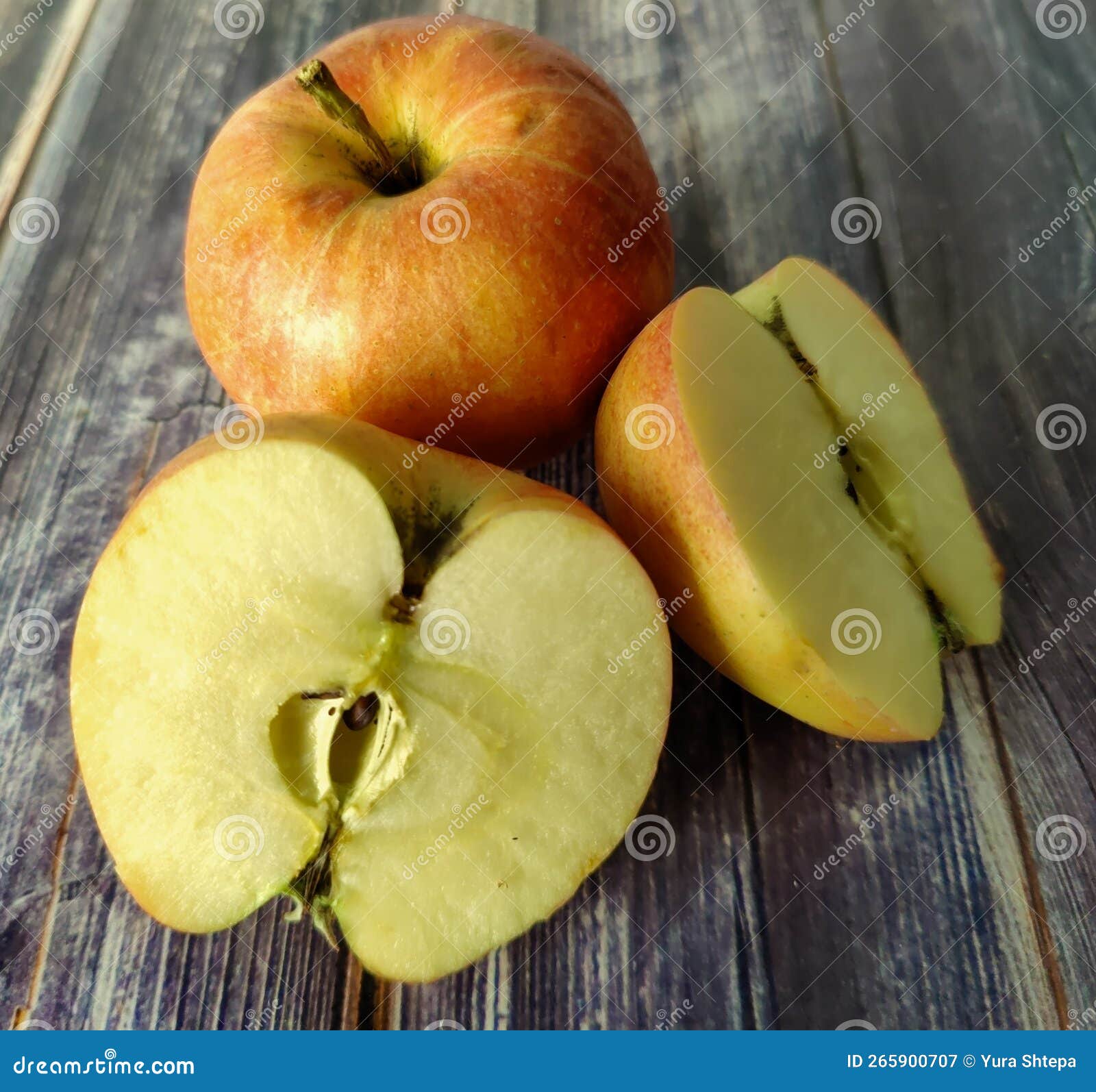 Whole Red Apple and Two Half on a Wooden Table. Close-up Stock Image ...