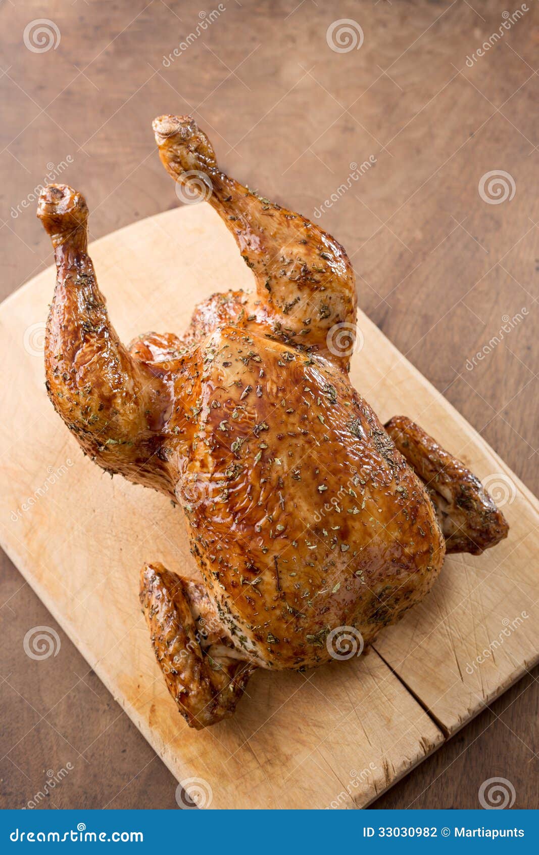 Whole Roast Chicken on Wooden Table Stock Photo - Image of crispy, skin ...