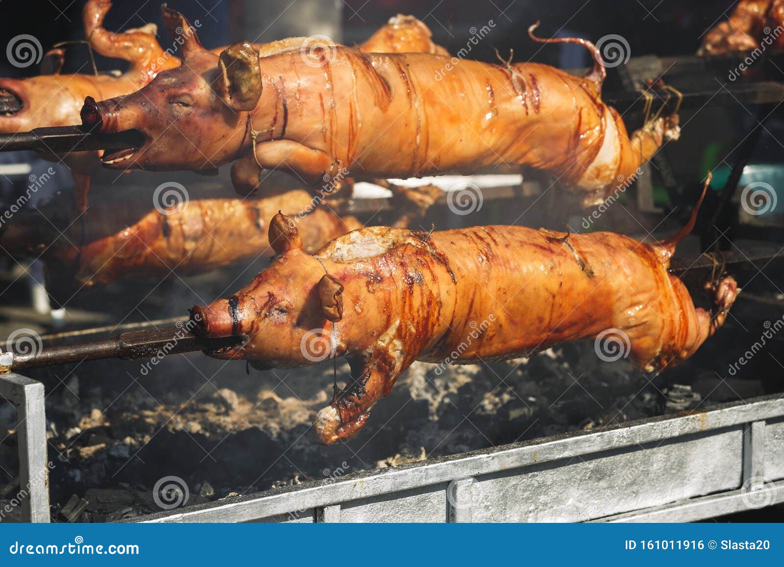 Whole Roasted Pigs on Spit Above Smoking Barbecue Stock Photo - Image ...