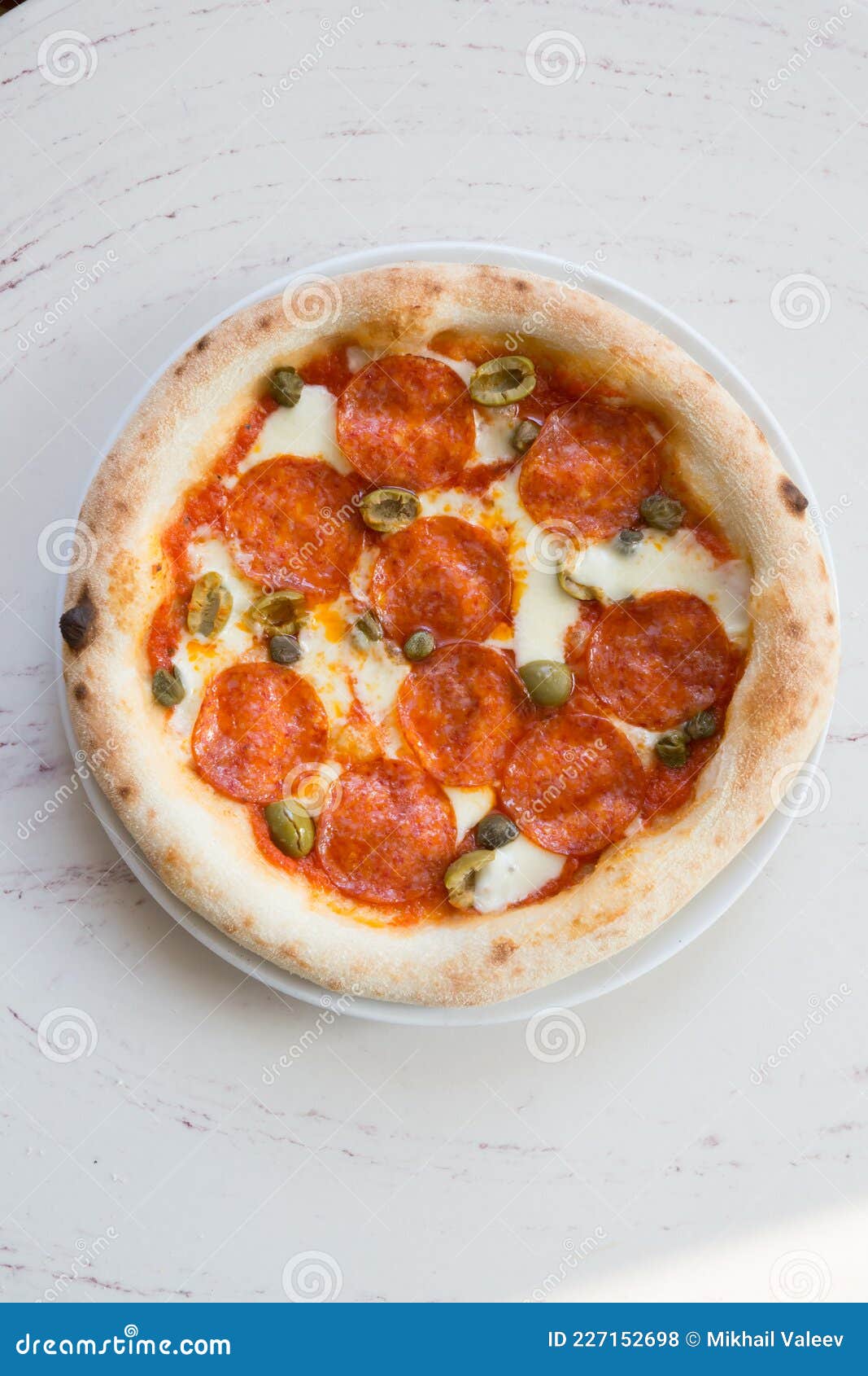 Whole Round Neapolitan Pepperoni Pizza Served on a Table Stock Photo ...