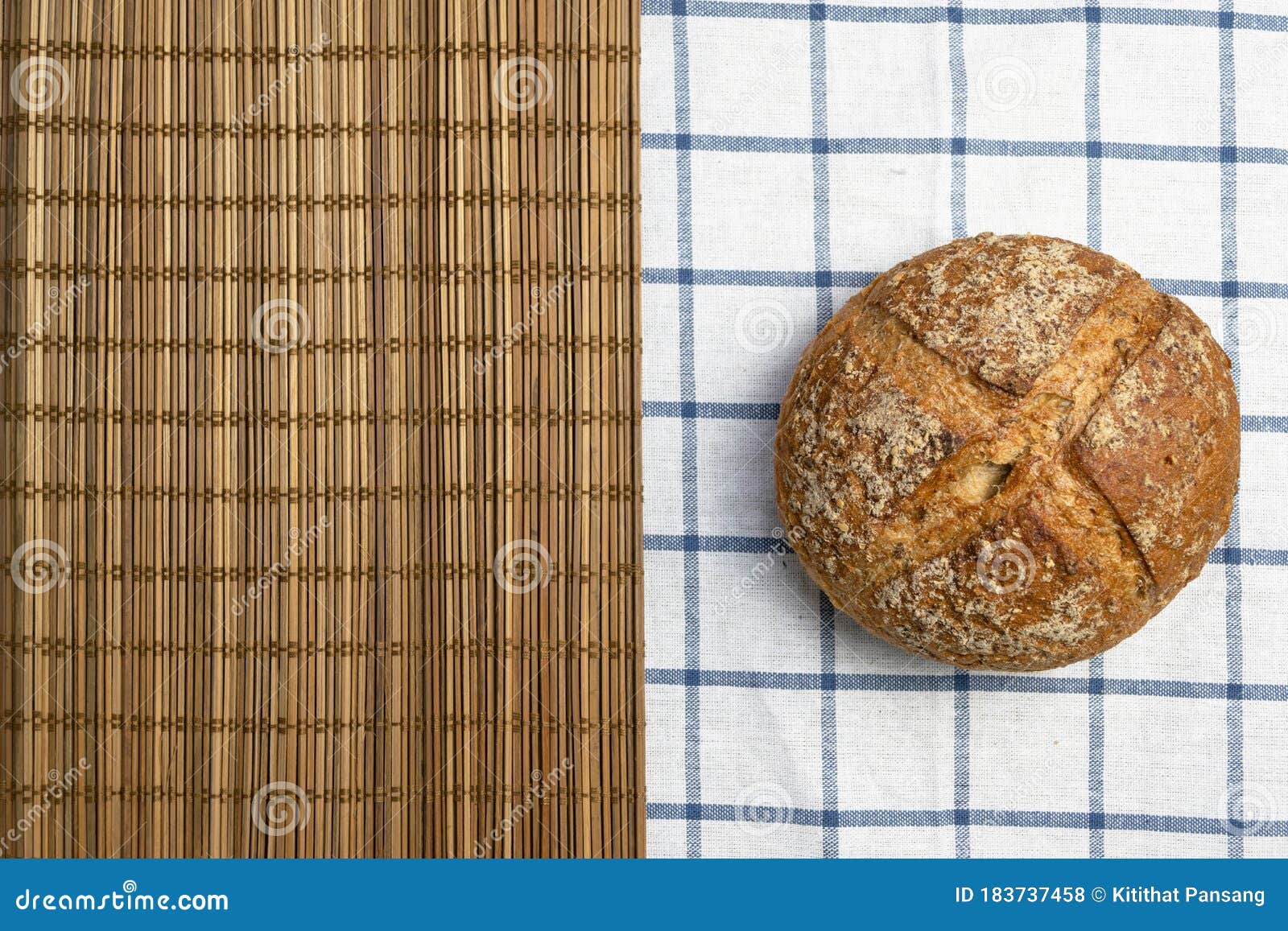 Whole Rye Bread Placed and Brown Bamboo Mat Over Table Cloth with Grid ...