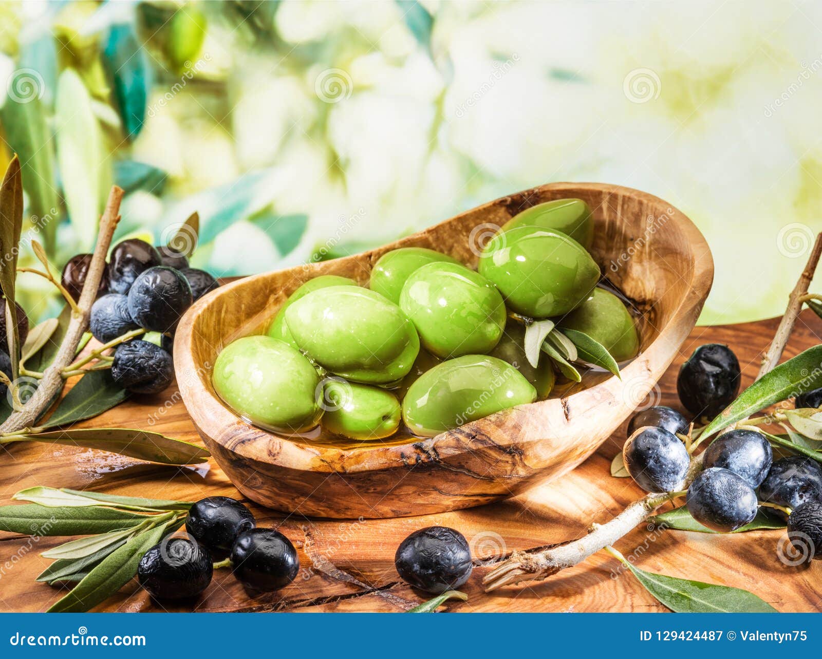 Whole Table Olives in the Wooden Bowl on the Table. Stock Image - Image ...