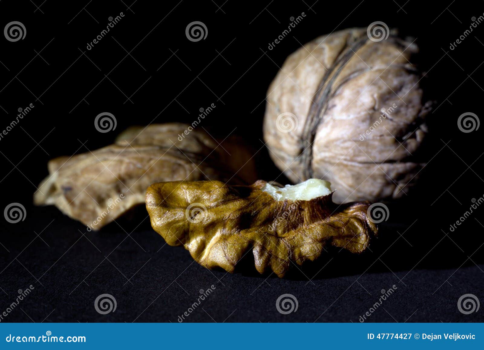 Whole Walnut and a Cracked Walnut on Black Background Stock Image ...
