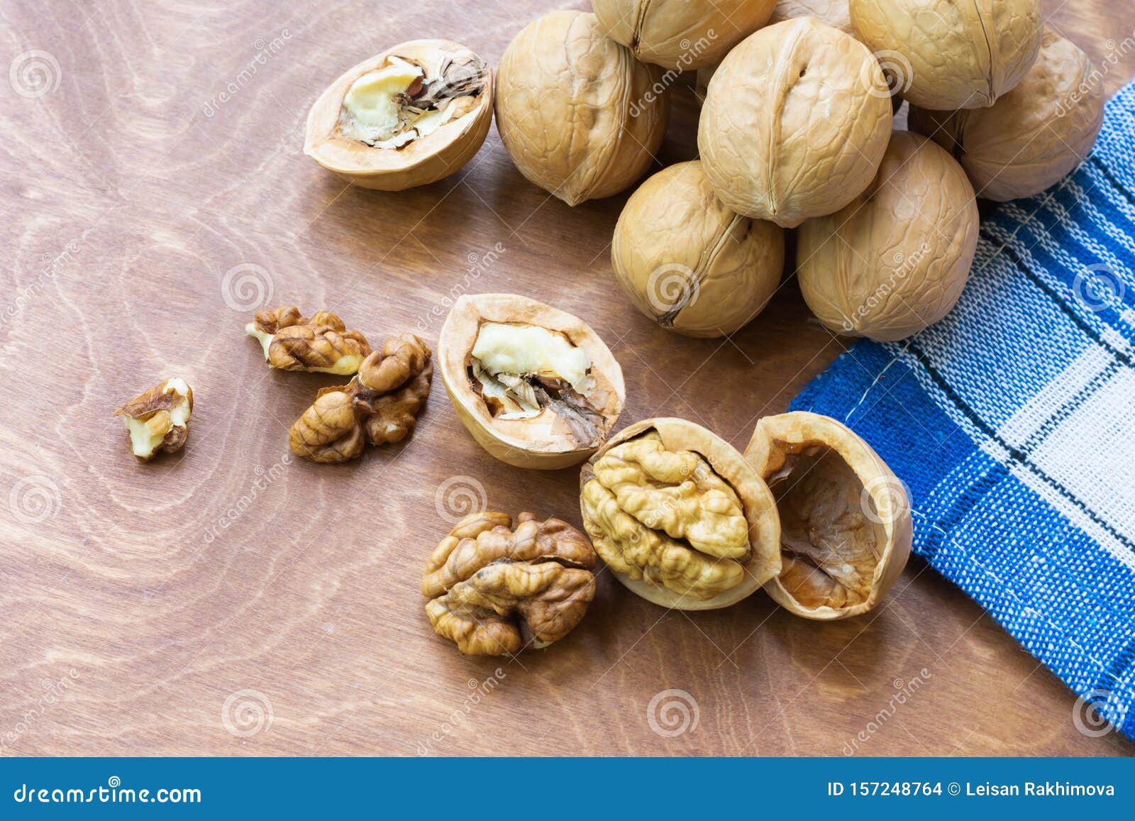 Whole Walnuts and Walnut Kernel Halves without Shell on a Dark Wooden ...