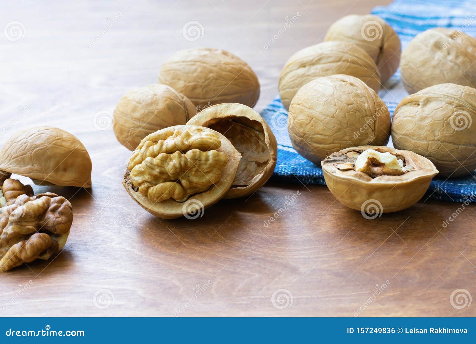 Whole Walnuts and Walnut Kernel Halves without Shell on a Dark Wooden ...