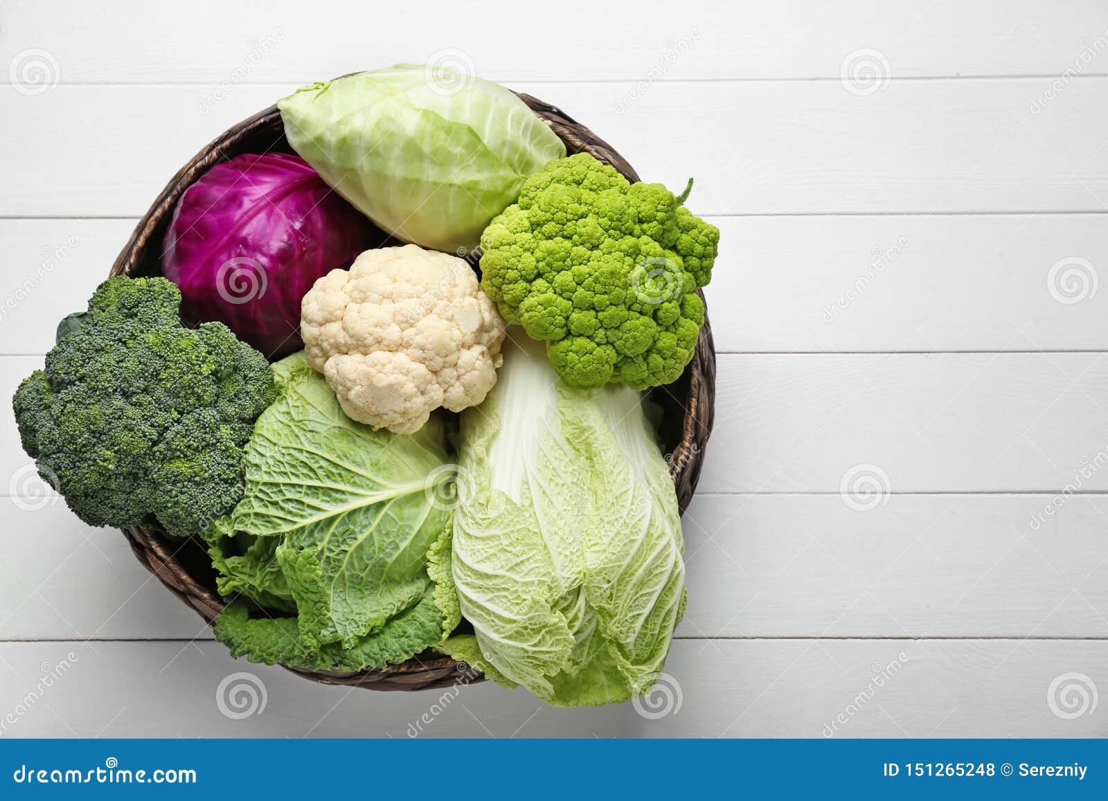 Wicker Basket with Different Kinds of Cabbage on White Wooden Table ...