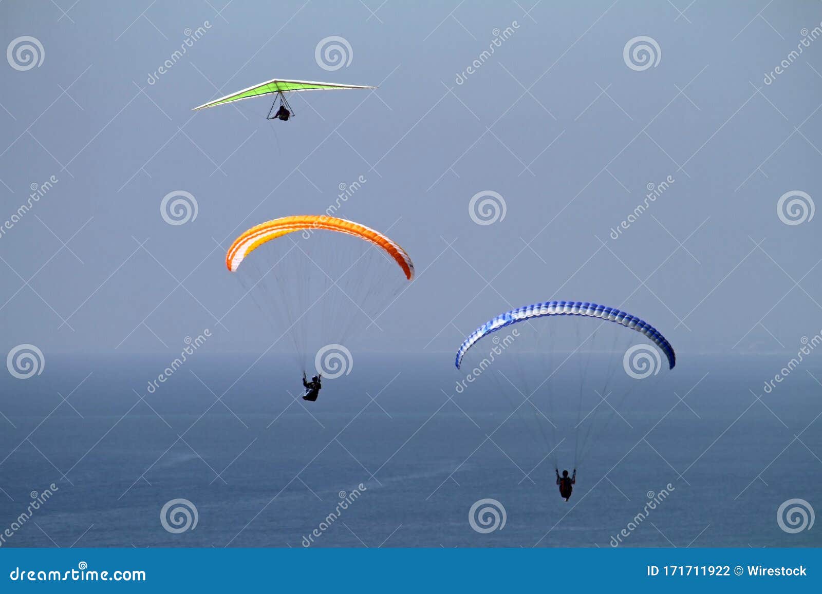 Wide Angle Shot of Three Parachutes Flying Over the Ocean Stock Photo ...