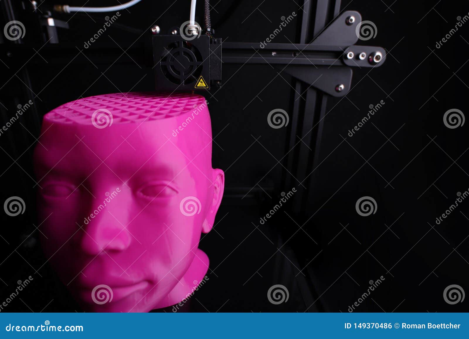 Wide Angle View on a 3D Printer Manufacturing a Humanoid Head from Pink ...