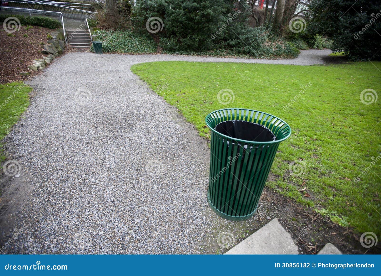 Wide Angle View of Trash Can by a Path in a Park Stock Photo - Image of ...