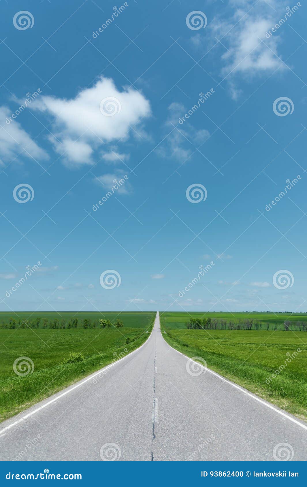 A Wide Asphalt Road between Green Fields Stock Photo - Image of blue ...